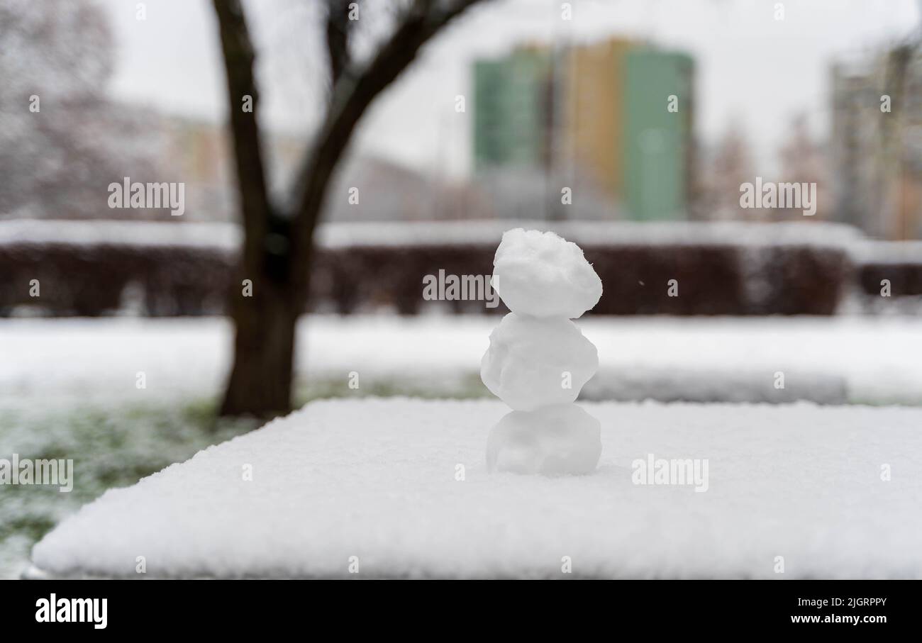 Round real snow balls kept on each other vertically on a table covered ...