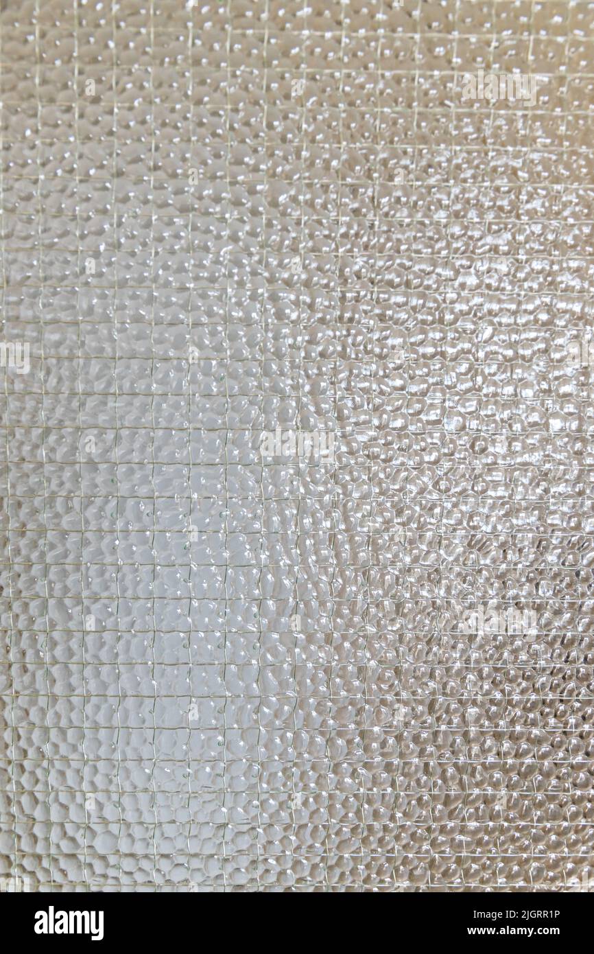 A piece of glass tile with embossed squares, wallpaper sample Stock ...