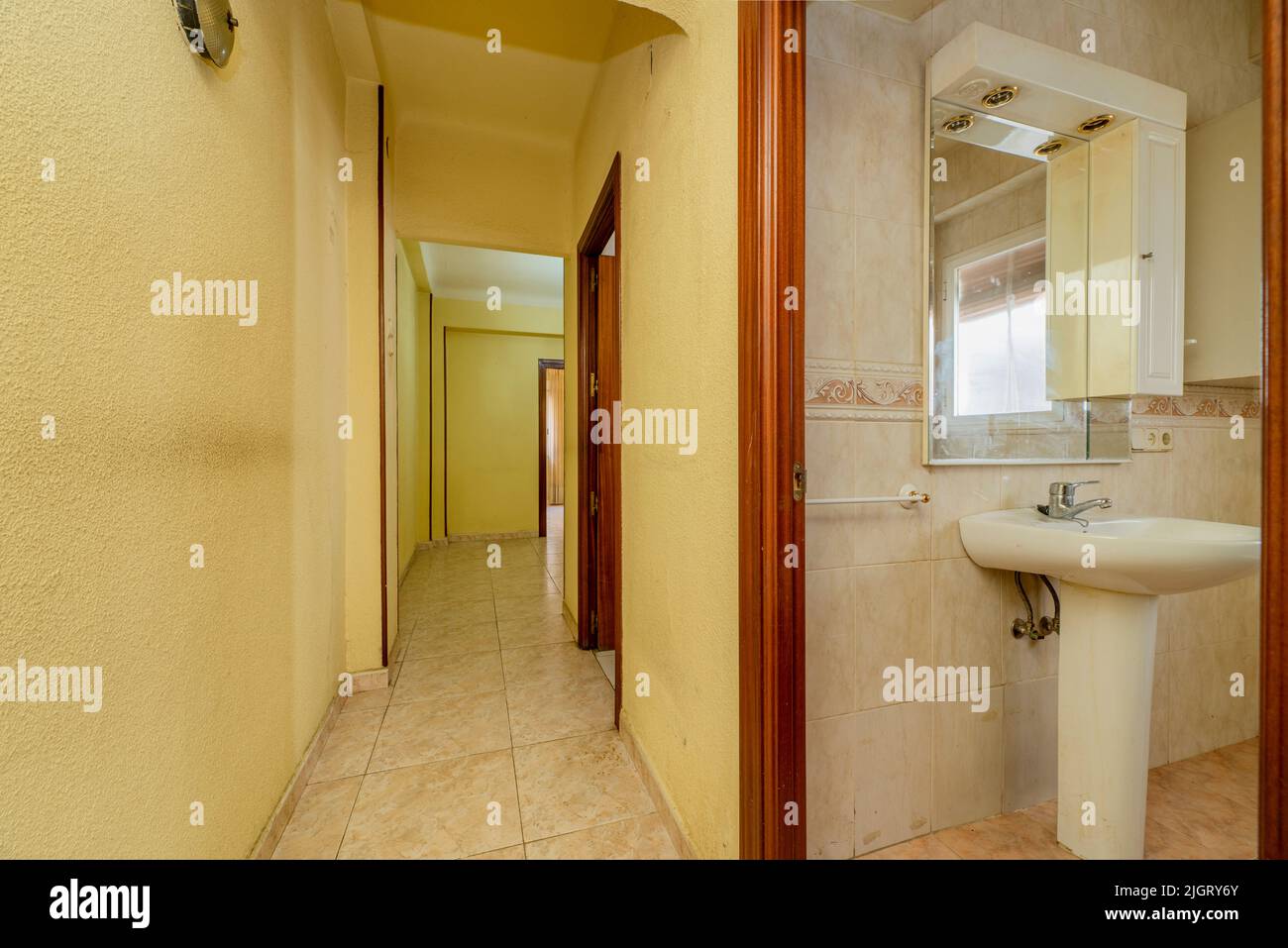 Corridor with entrance to several rooms, including a bathroom with ...