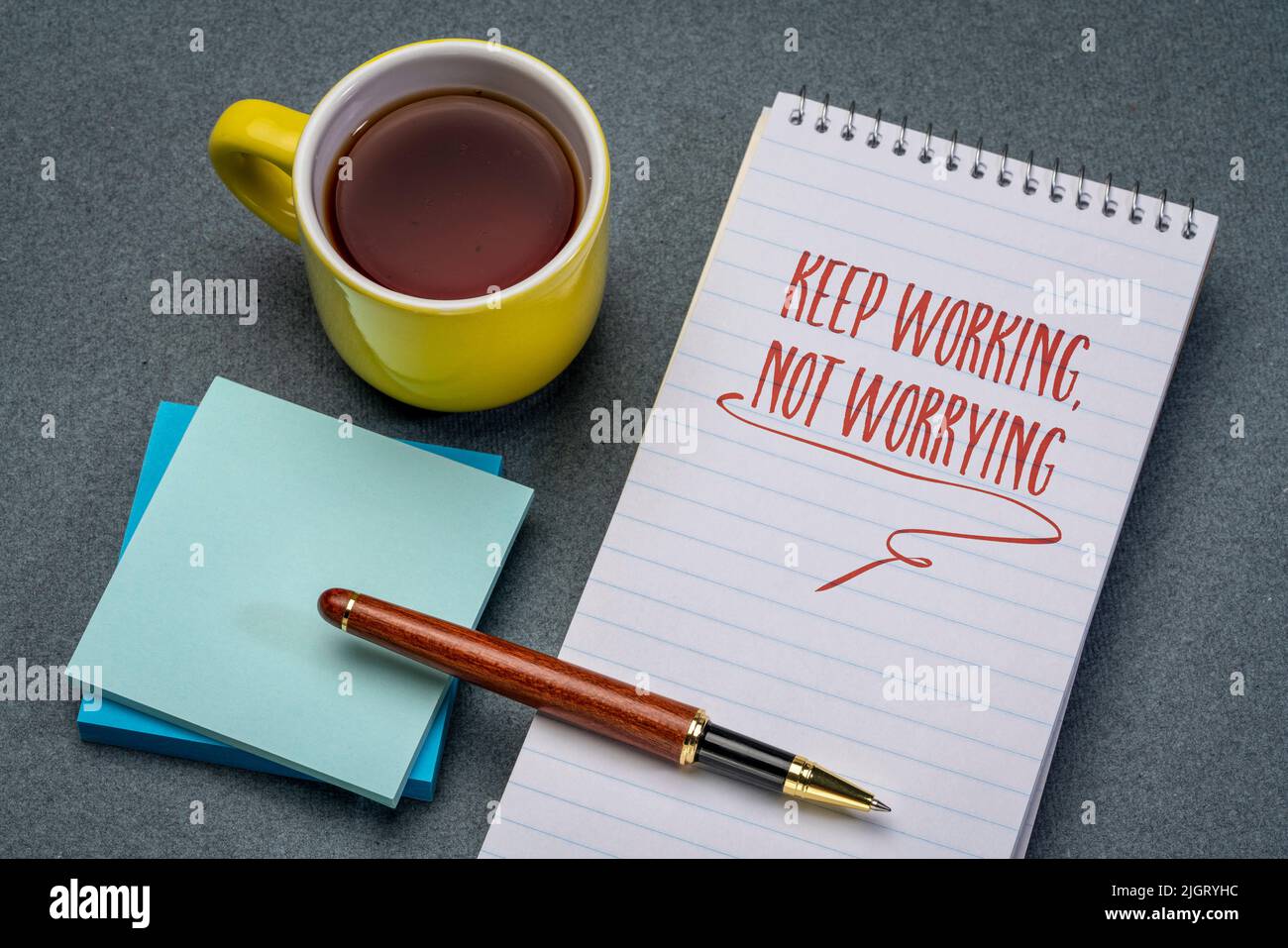 keep working, not worrying - inspirational reminder in a notebook ...