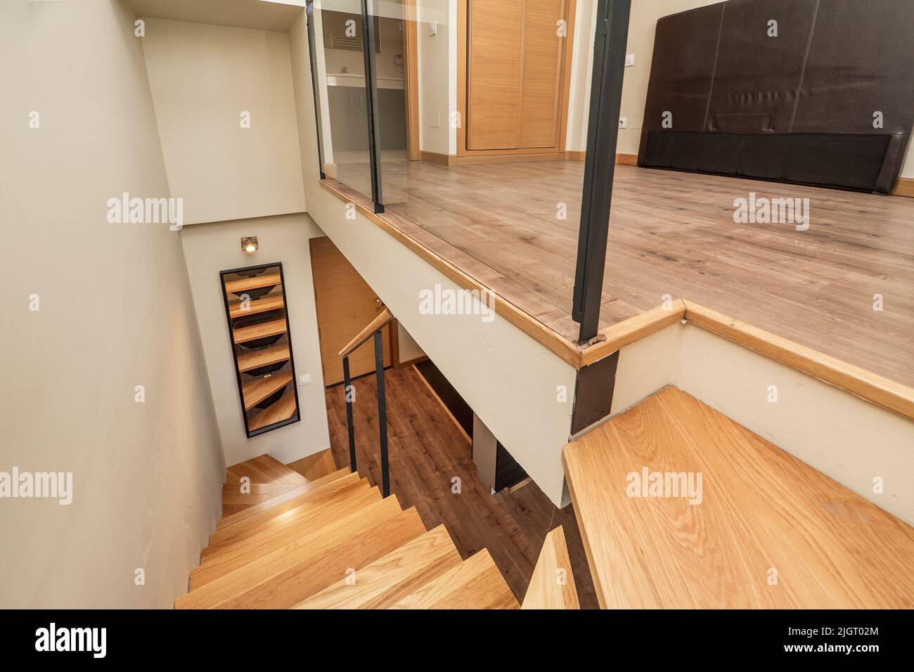 Up and down stairs of a residential loft house with wooden steps and ...