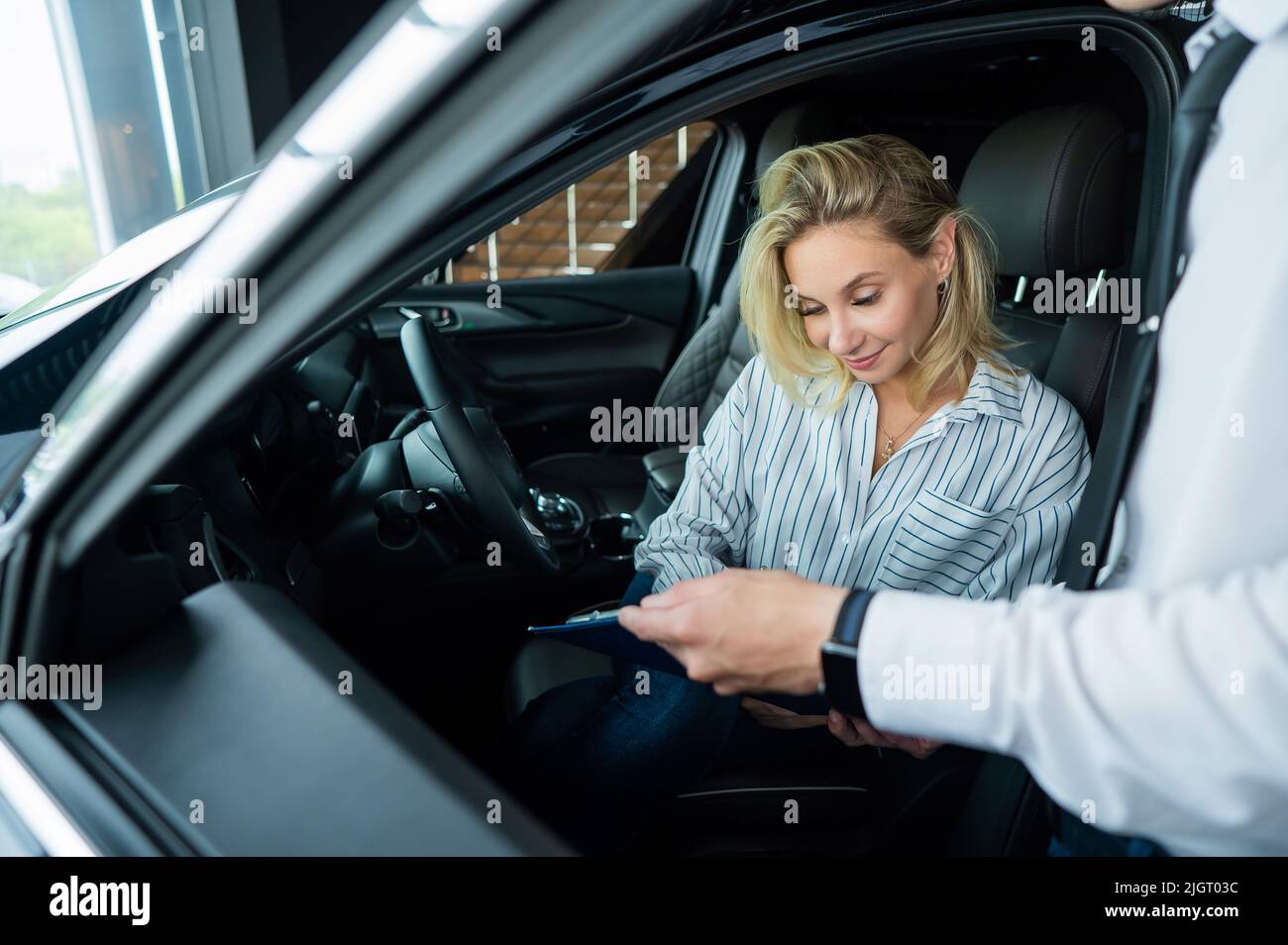 Girl signing document sitting hi-res stock photography and images - Alamy