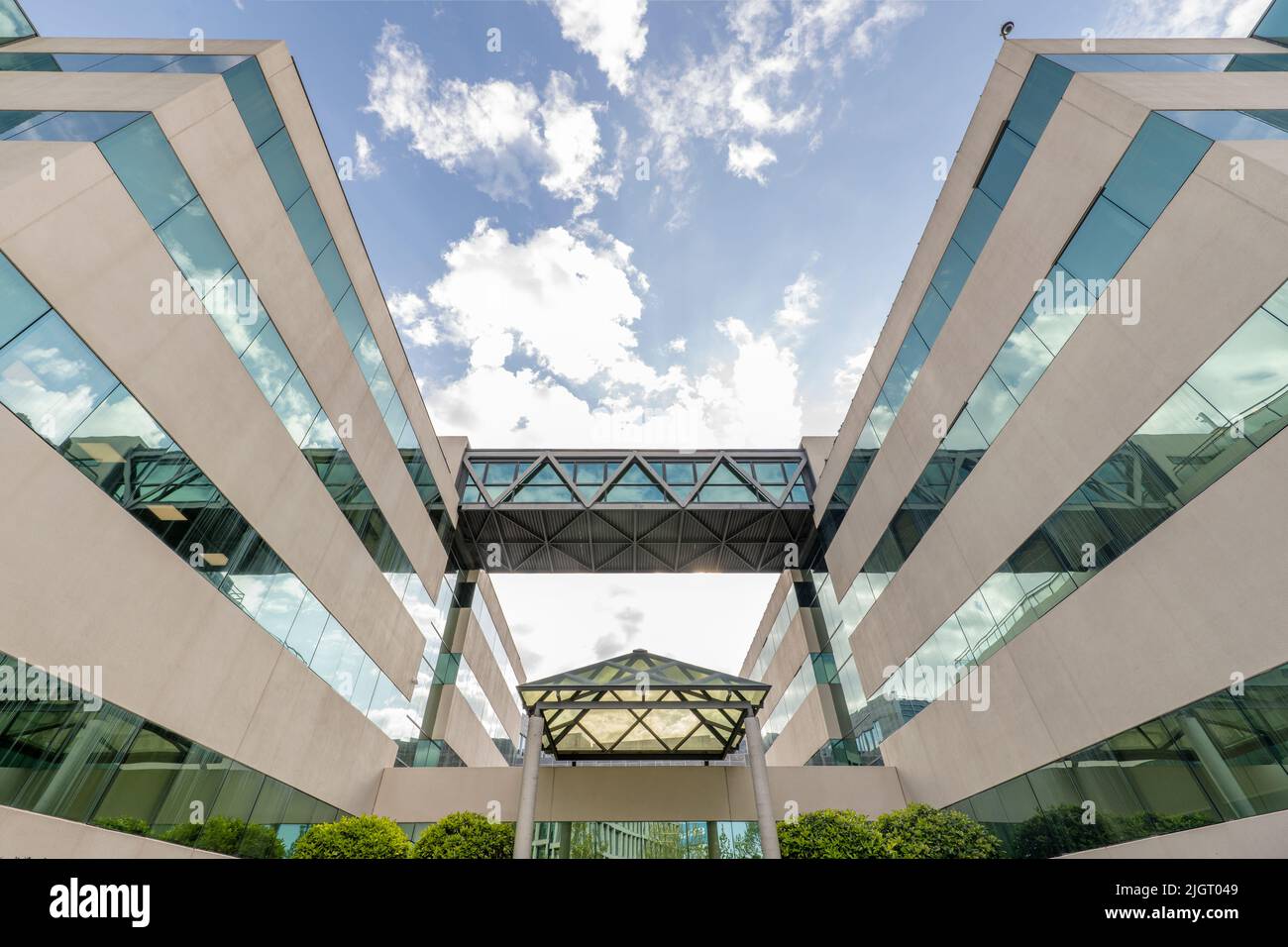 Entrance of an office building with concrete and glass facades and ...