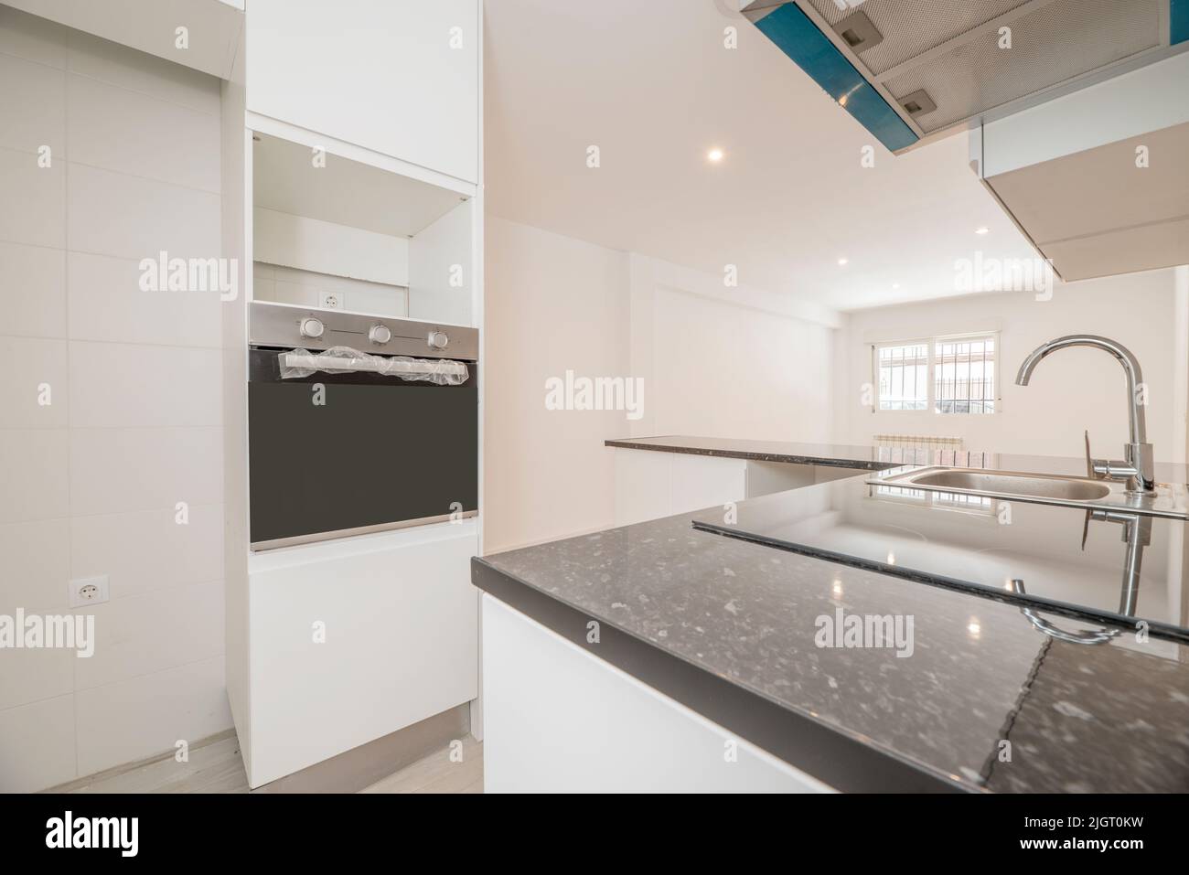 Newly installed kitchen with shiny countertops, glass and stainless ...