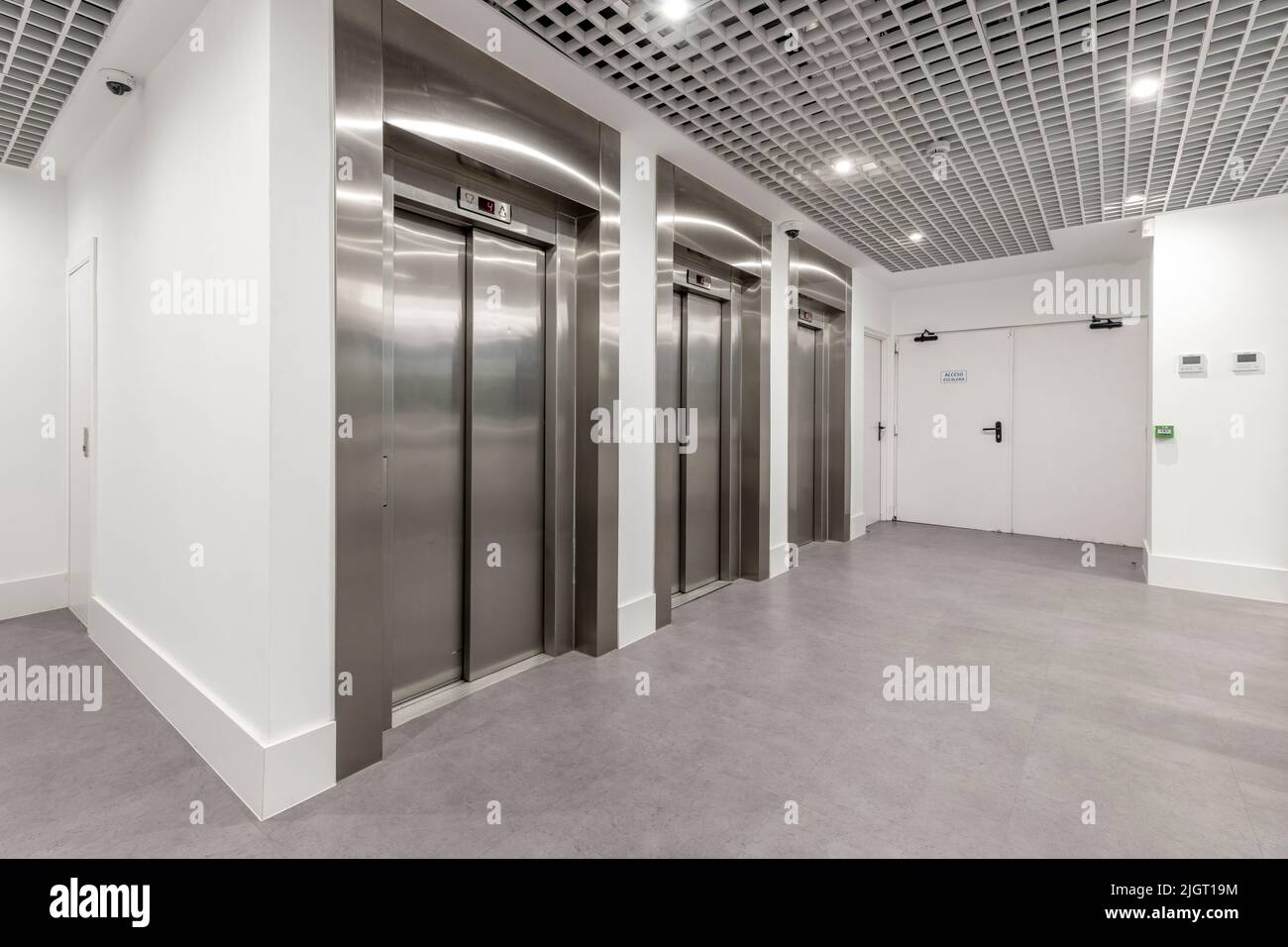 Stainless steel elevator bank in the lobby of an office building Stock ...