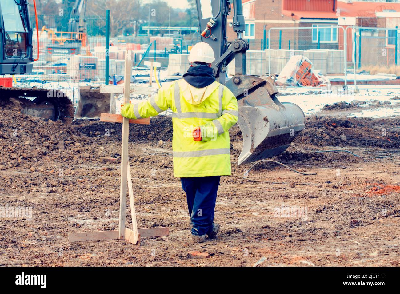 Excavator digging and levelling ground on construction site. Digging to ...