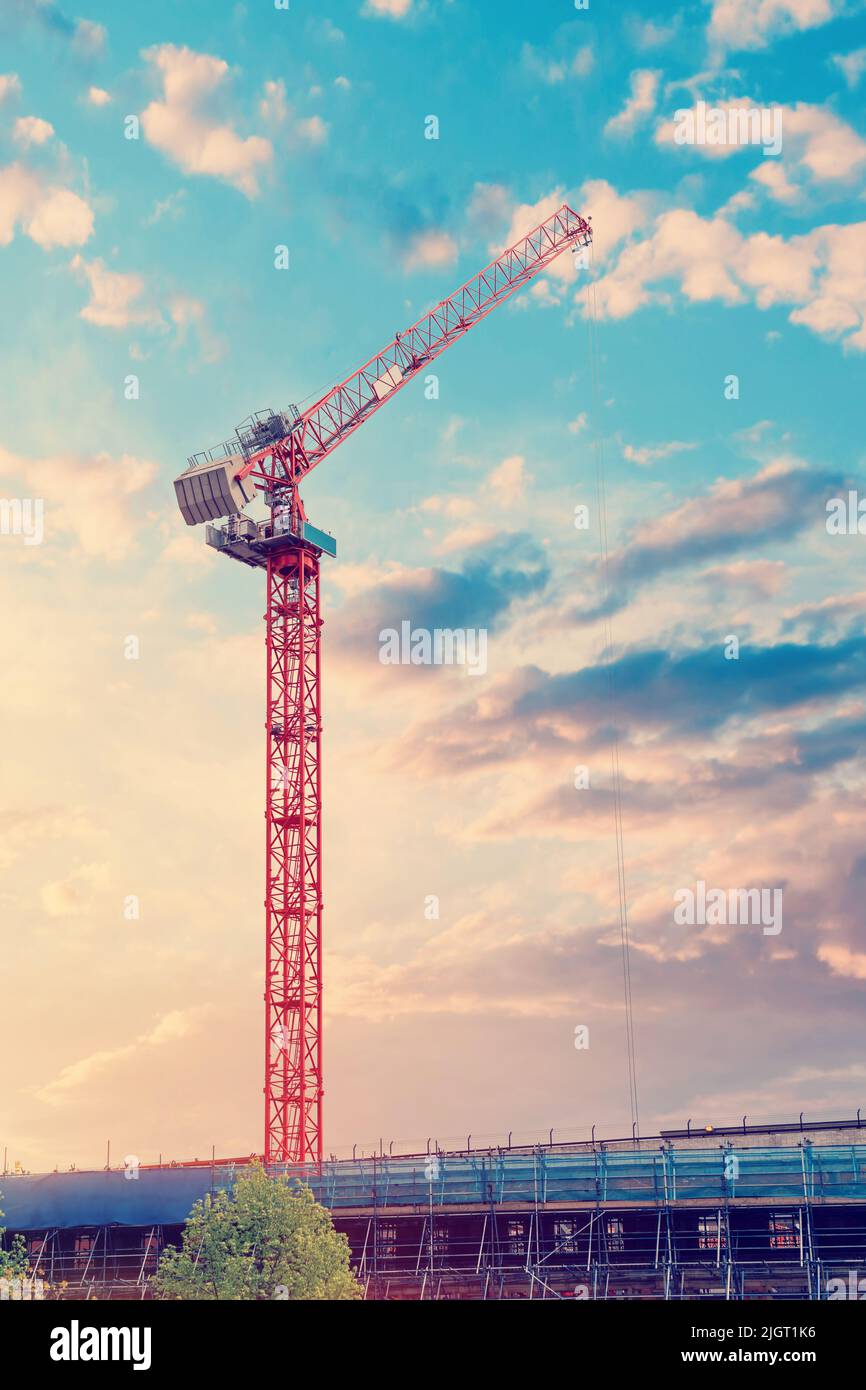 Tower crane on a dramatic sky background Stock Photo - Alamy