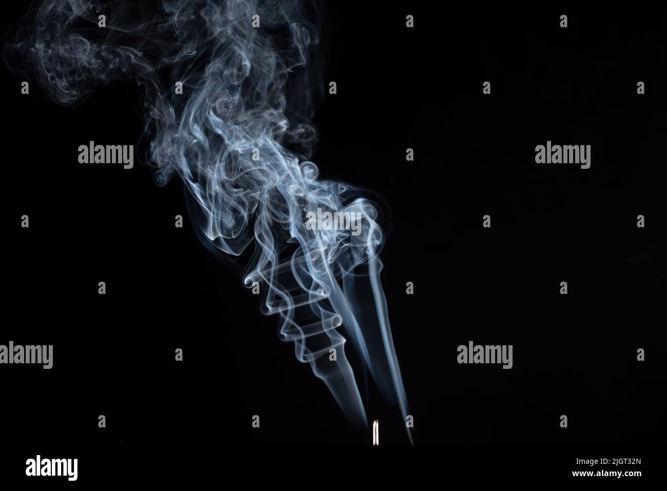 incense stick with smoke against black background Stock Photo - Alamy