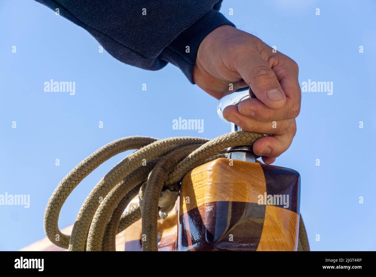 a man's hand holding a handle of the ship Stock Photo - Alamy