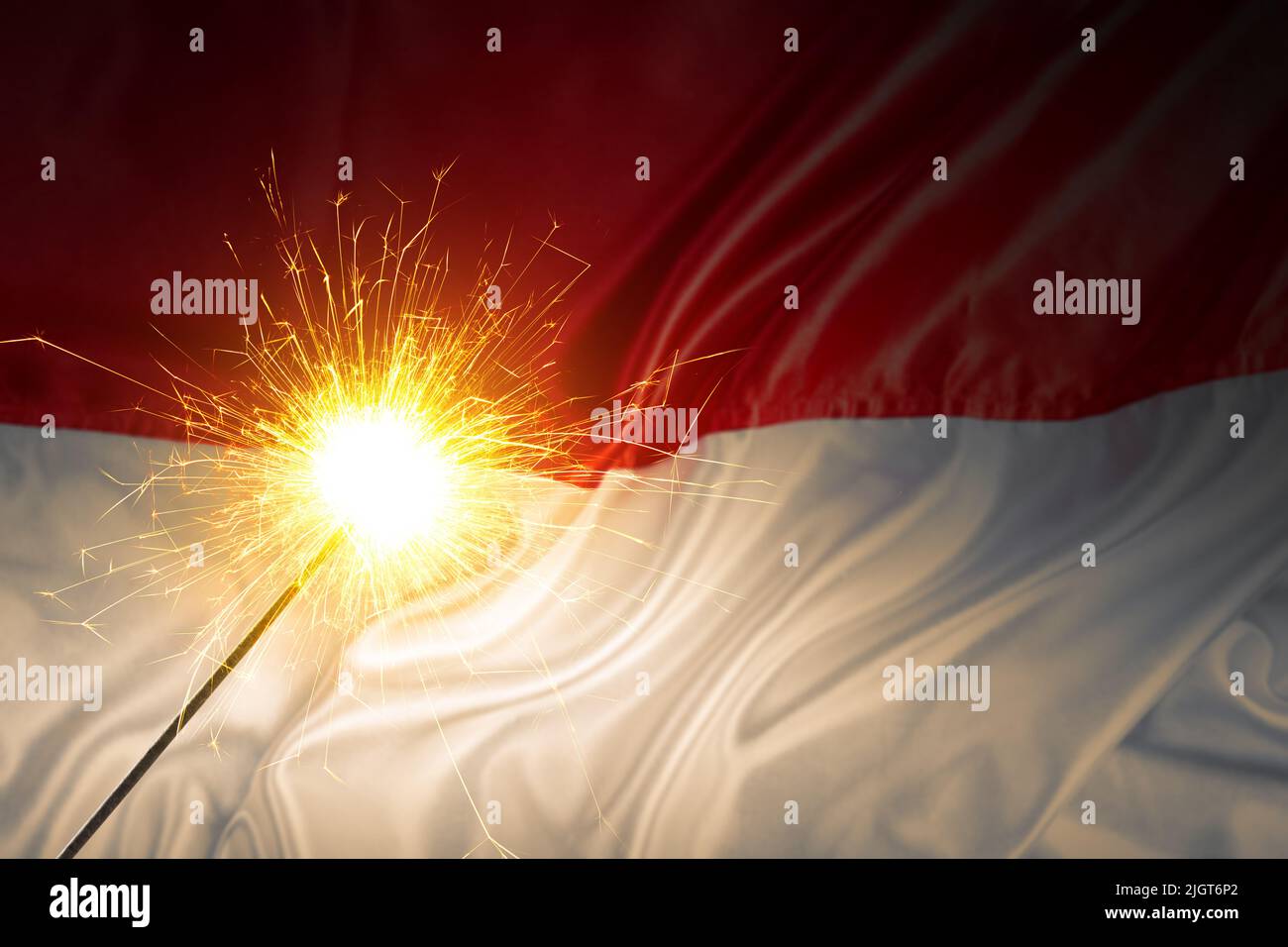 Human hand holding fireworks with a red and white flag background ...