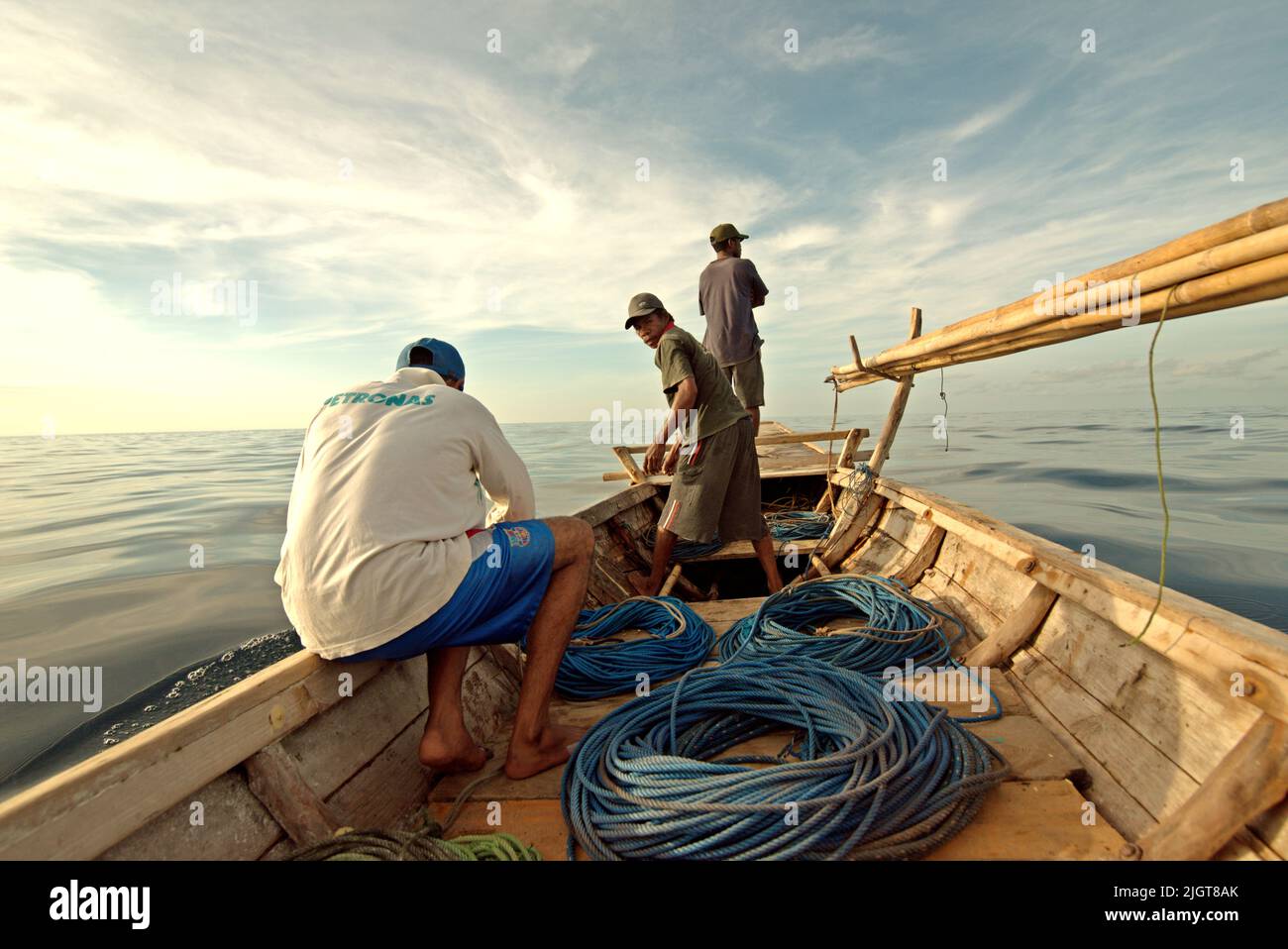 Whale hunters on traditional whaling boat equipped with bamboo harpoons ...