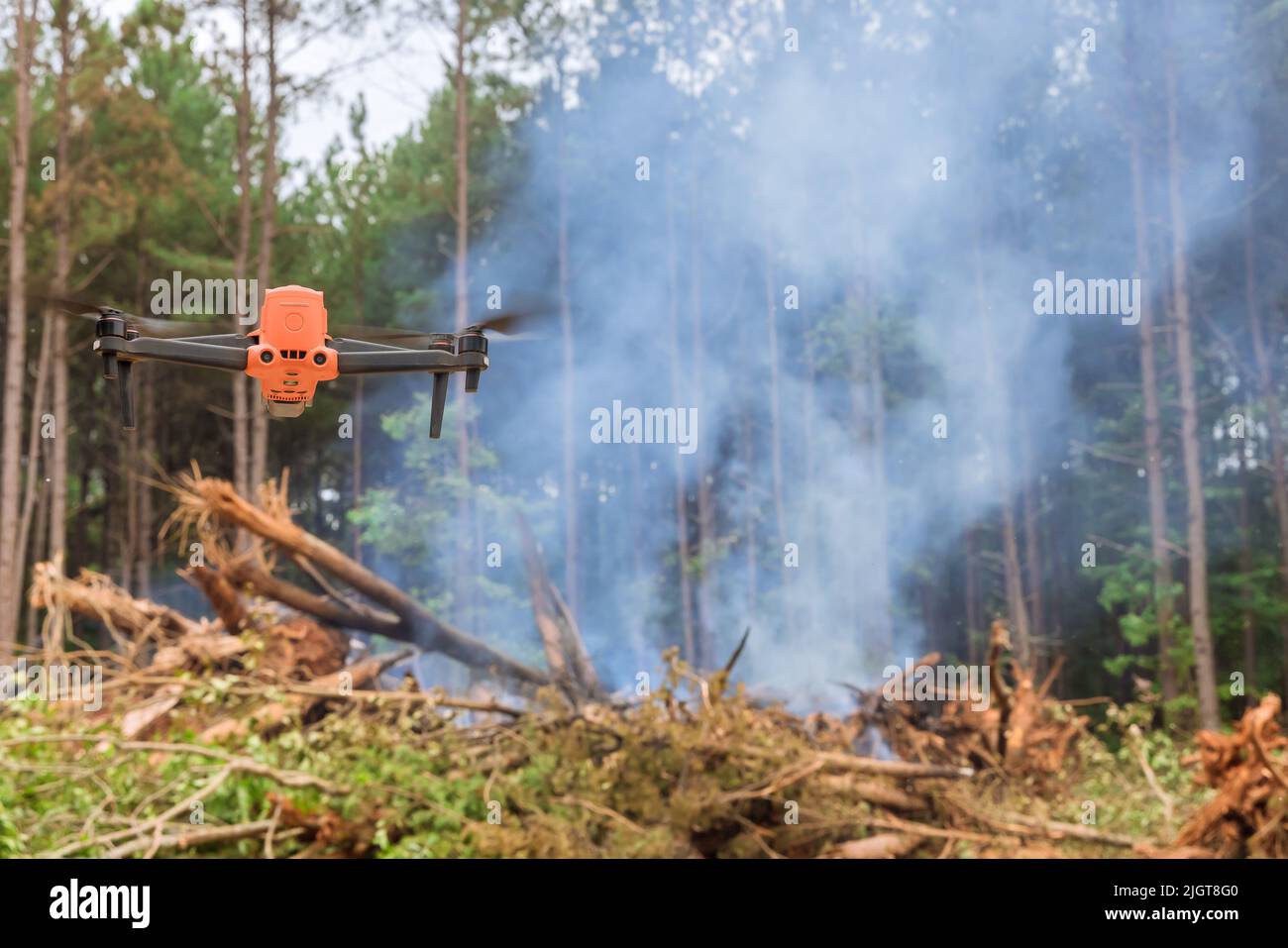 Using a drone, the fire services follow the fire into the forest trees ...