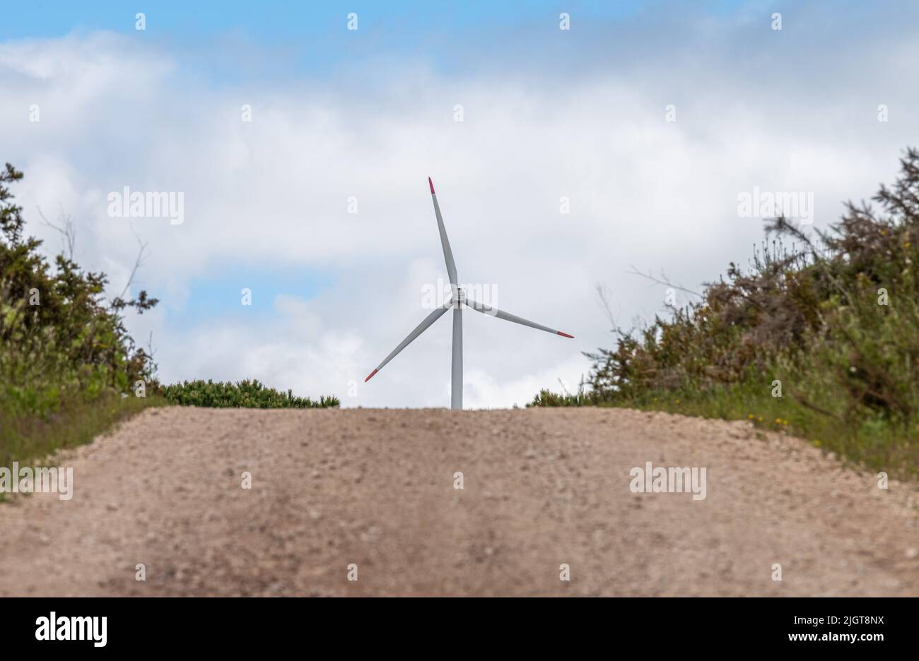 A road leading to a wind turbine Stock Photo - Alamy