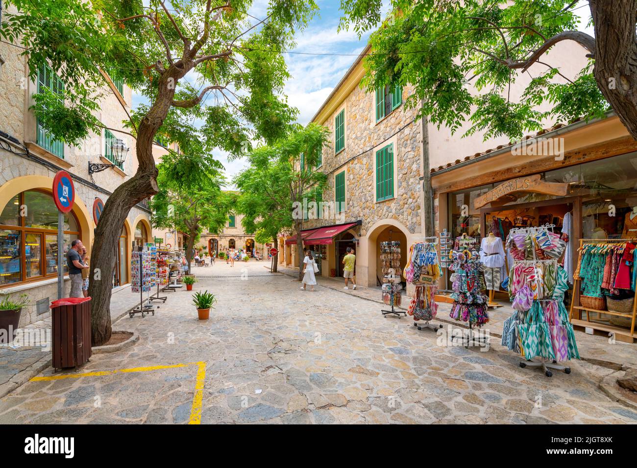 One of the many picturesque tree lined streets of shops and cafes in ...