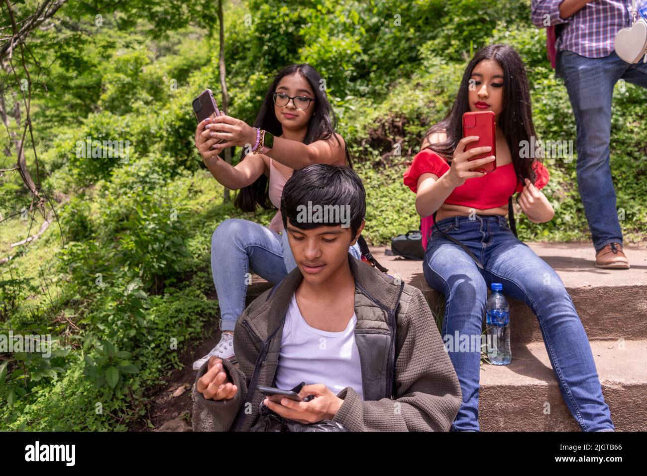 Group of Latin students having a moment of recreation Stock Photo - Alamy