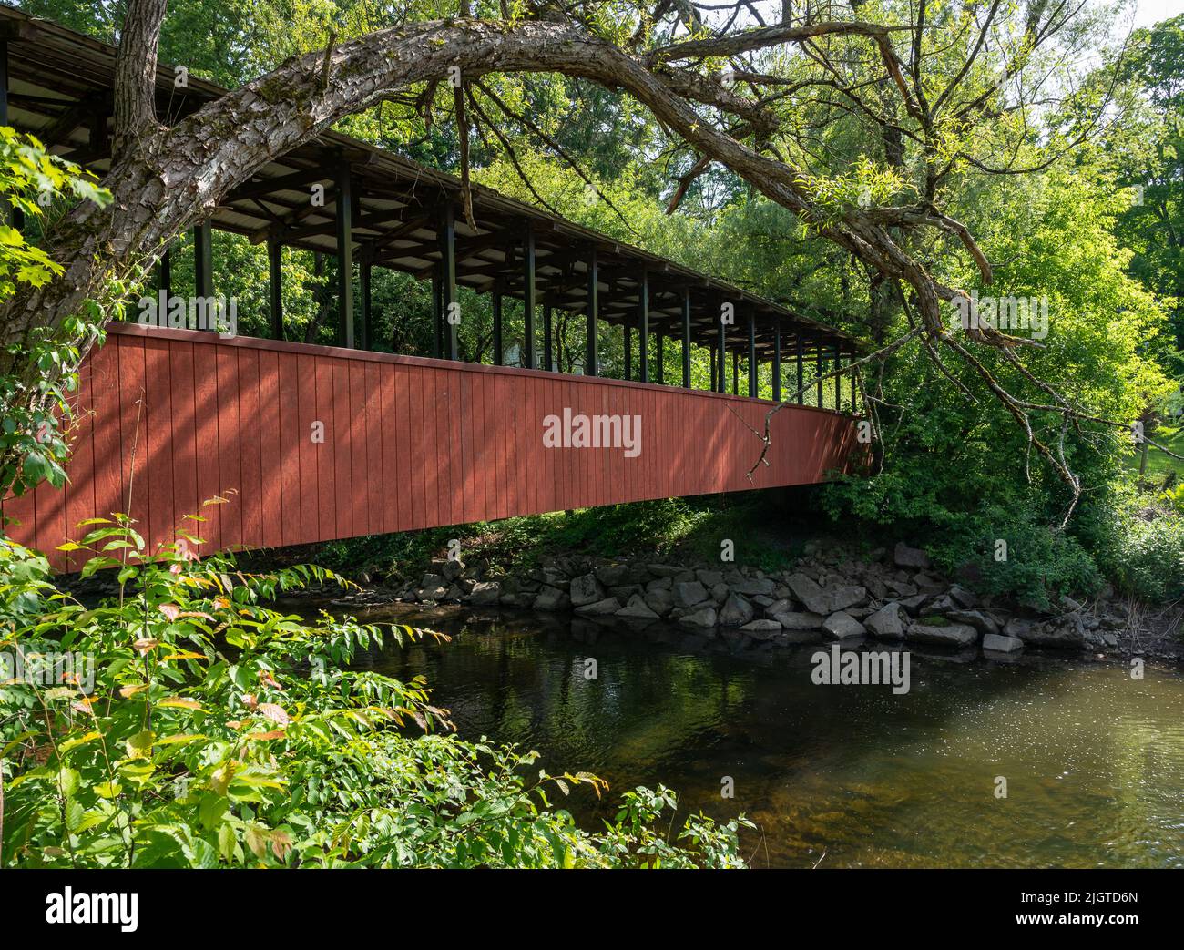 Covered bridge over a creek on a hiking path Stock Photo - Alamy