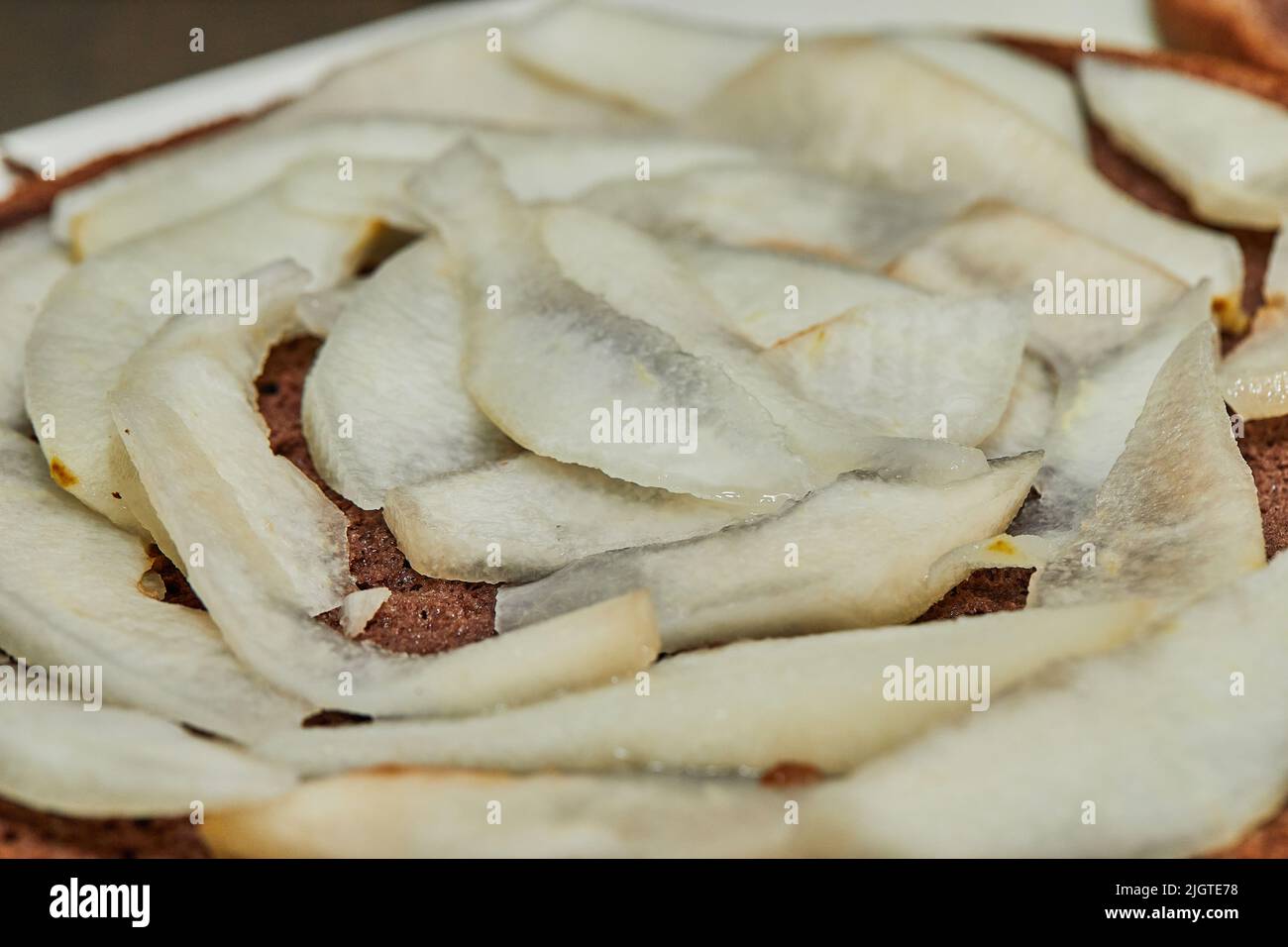 Chef puts the pears inside the pie to make pear and walnut pie Stock ...