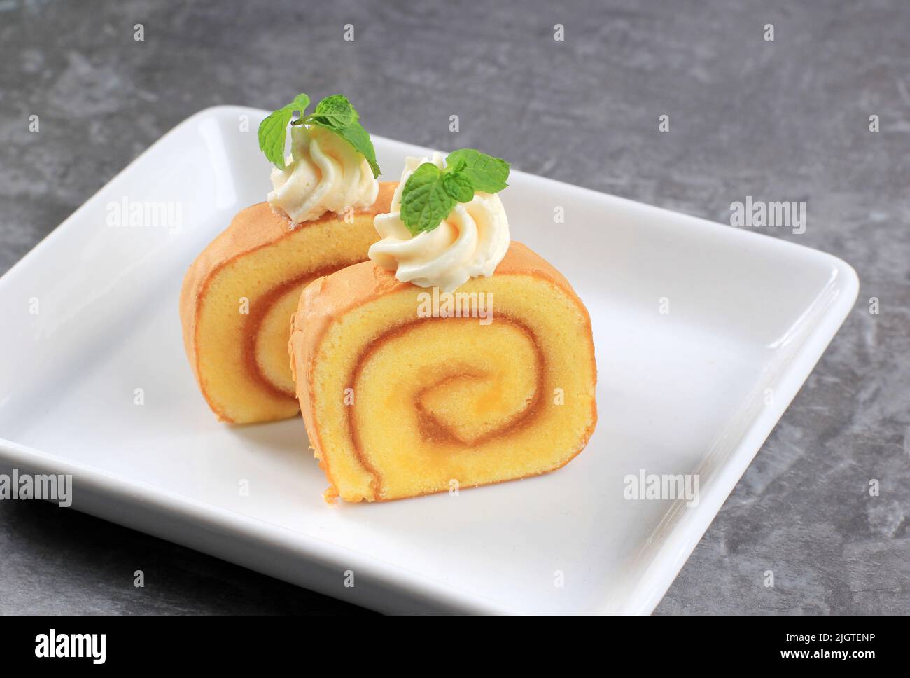 Slice of Swiss Roll with Pineapple, on White Plate Stock Photo - Alamy