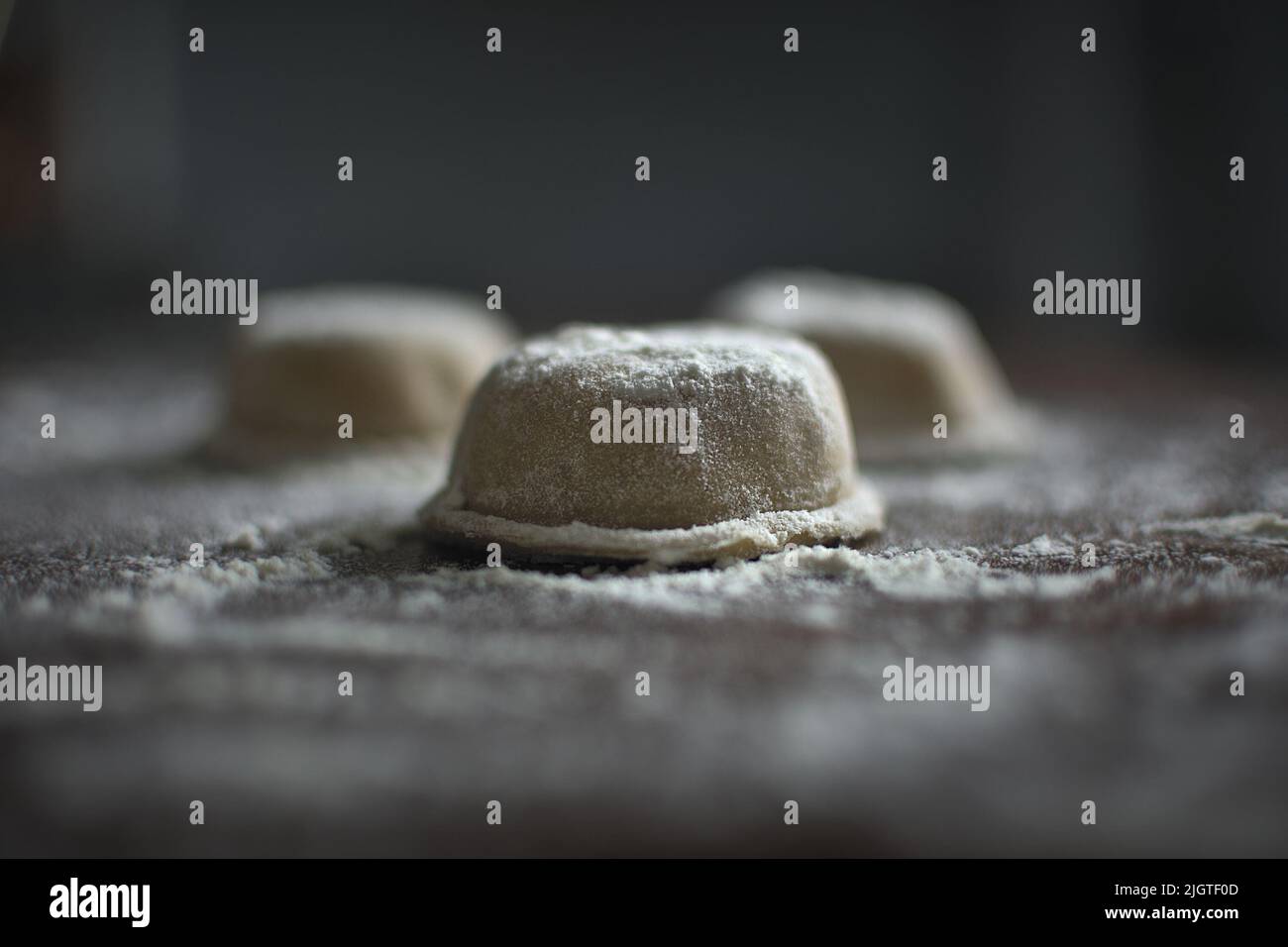 Healthy sourdough big ravioli (aka sorrentinos) over a floured wooden ...