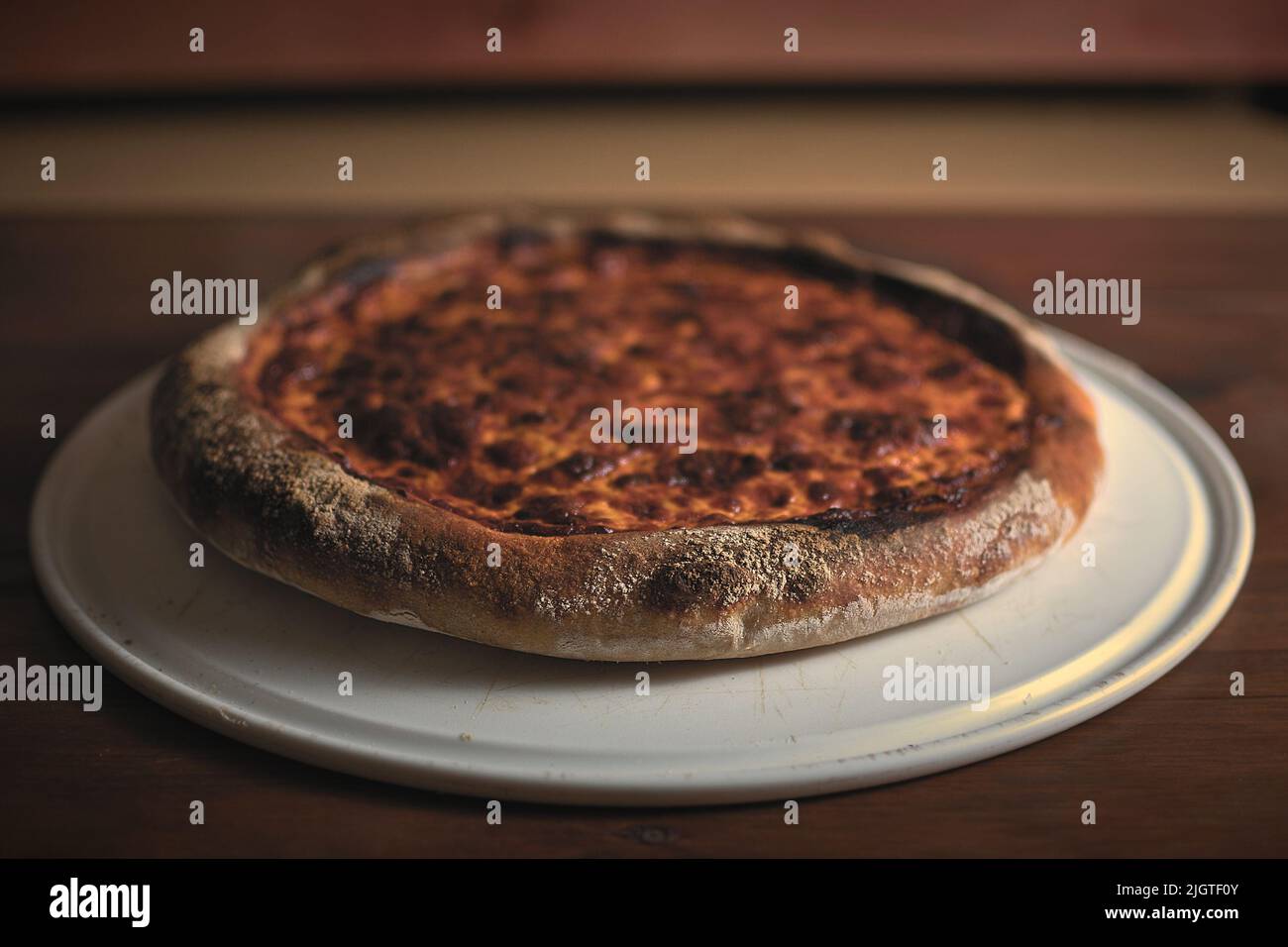 Perfect sourdough New York style pizza over a wooden table before going ...