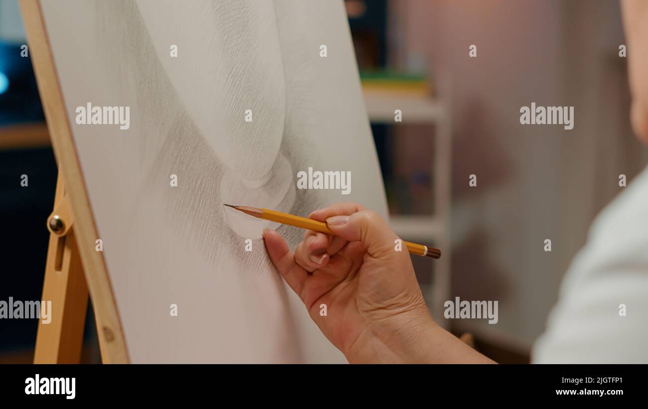 Hand of professional artist drawing vase model design with pencil on ...