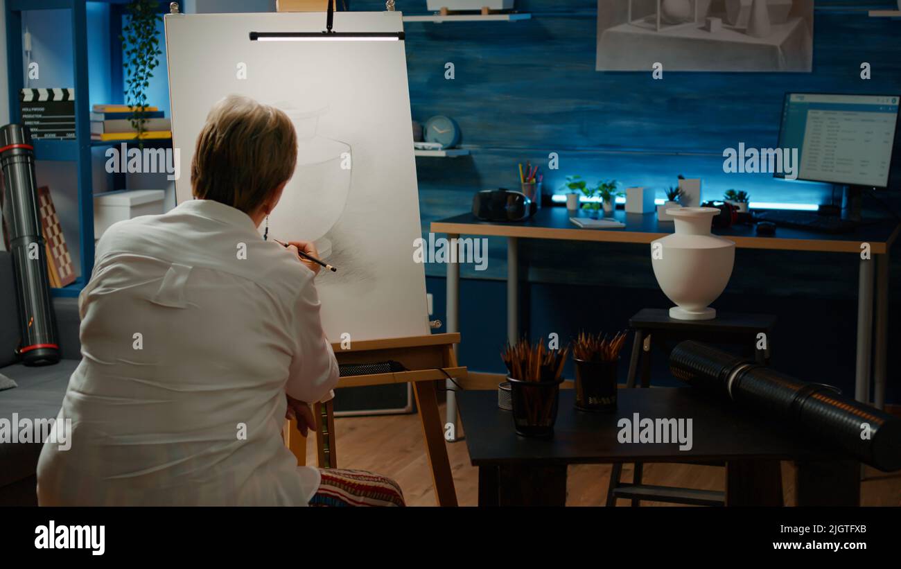 Senior artist drawing professional sketch with creative skills, using ...