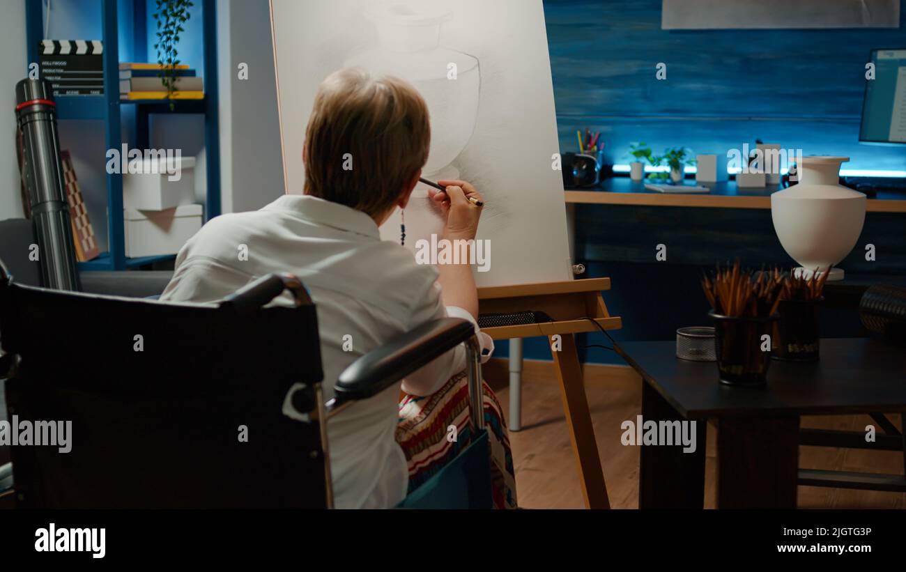 Retired person with physical impairment creating modern art design with ...