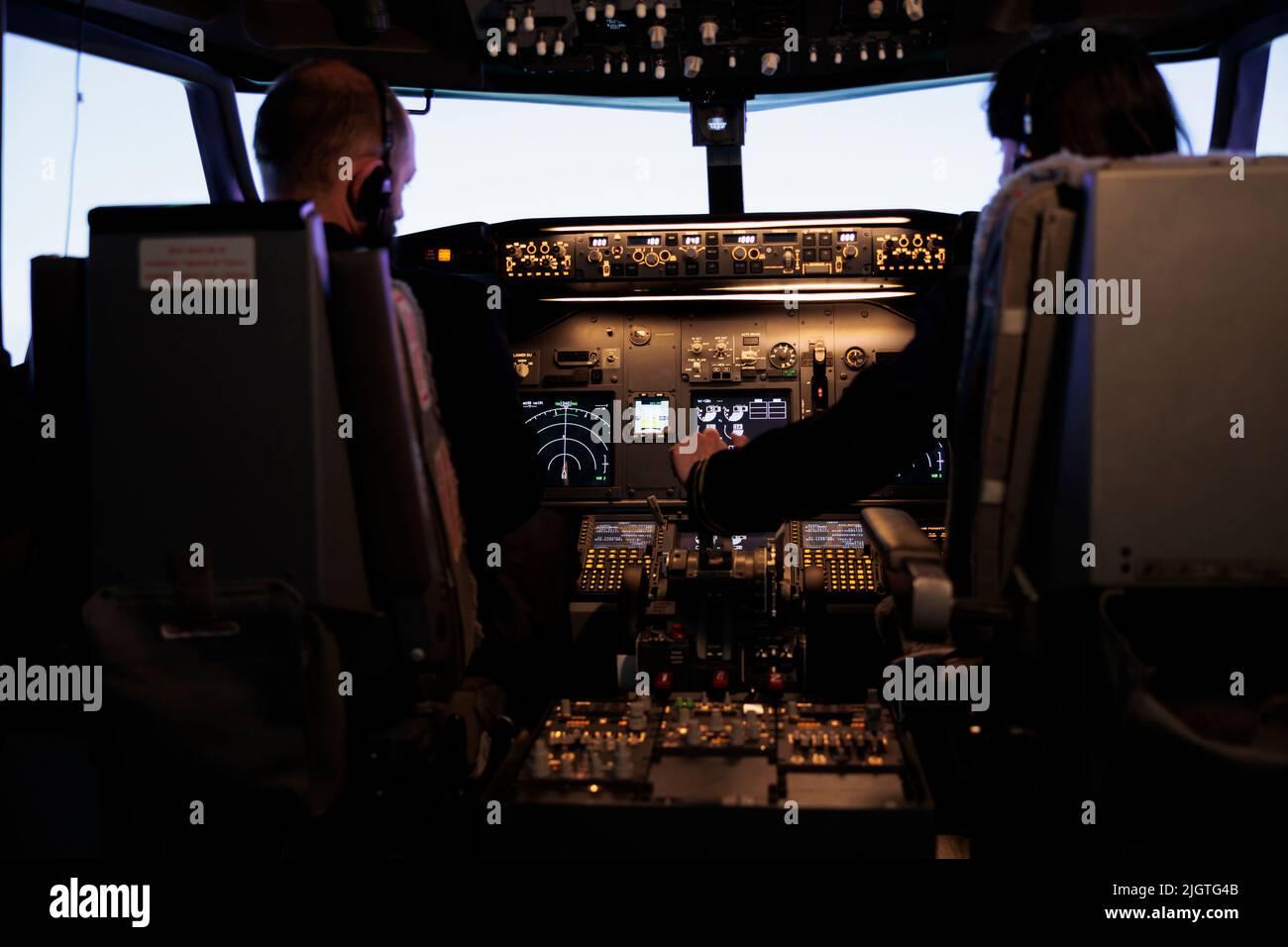 Team of aircrew members throttling engine to fly airplane, using ...