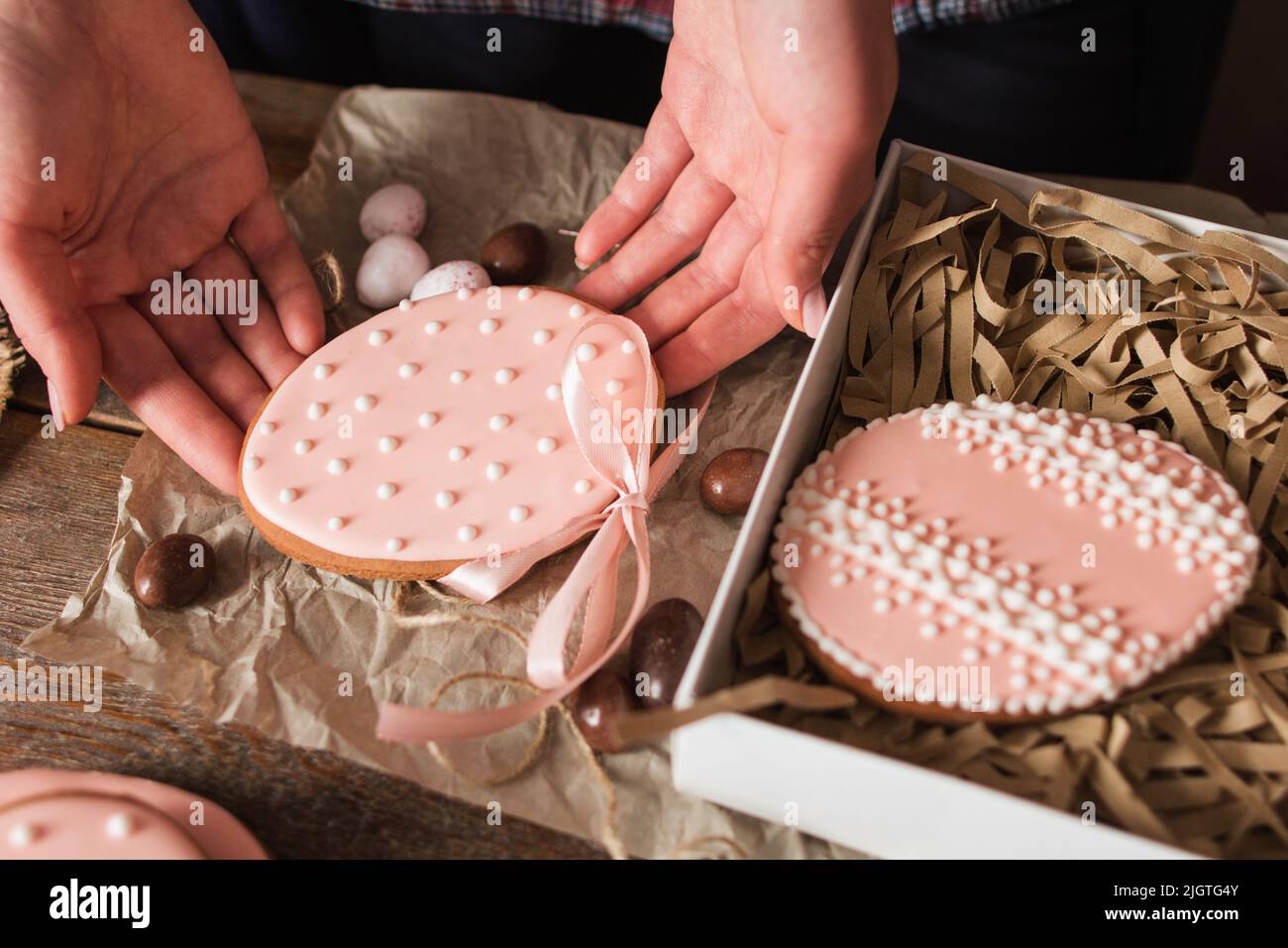 Woman packing handmade Easter cookies closeup Stock Photo - Alamy