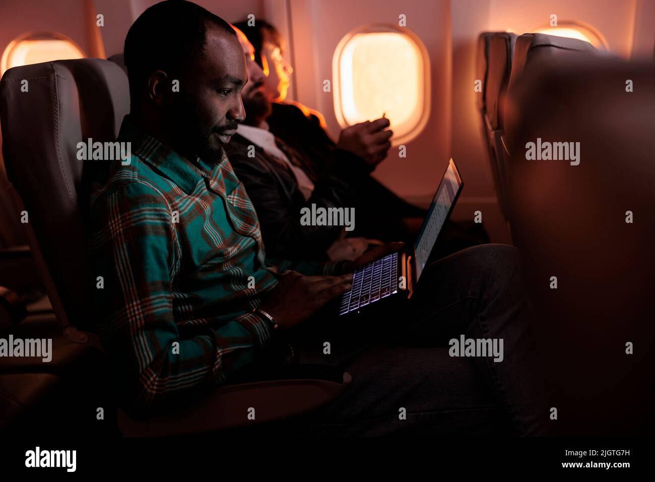 Modern traveller browsing internet on laptop and flying abroad in ...