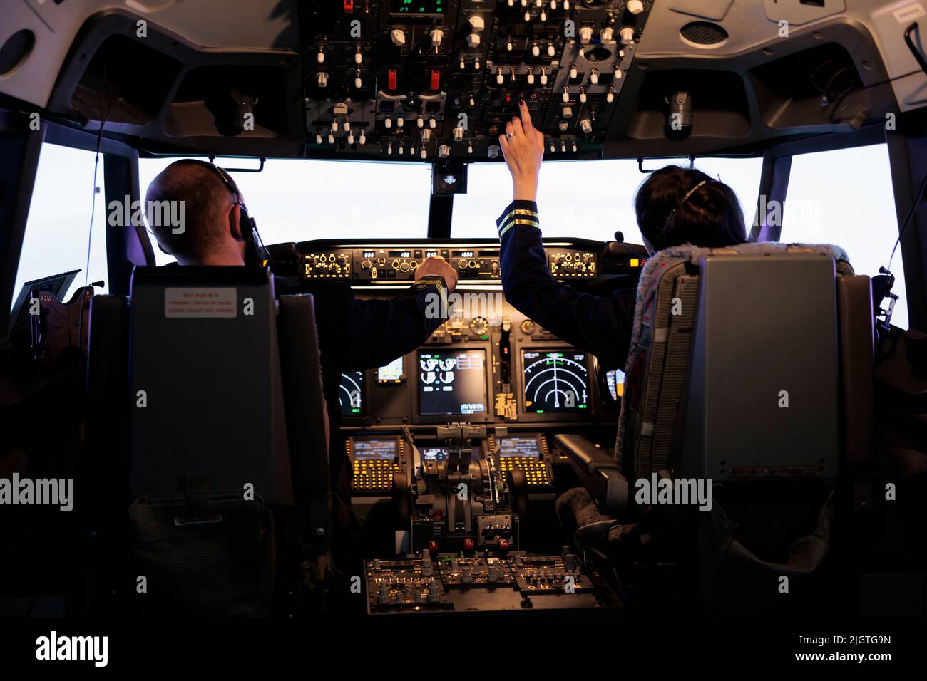 Captain and woman copilot getting ready to fly airplane and takeoff ...
