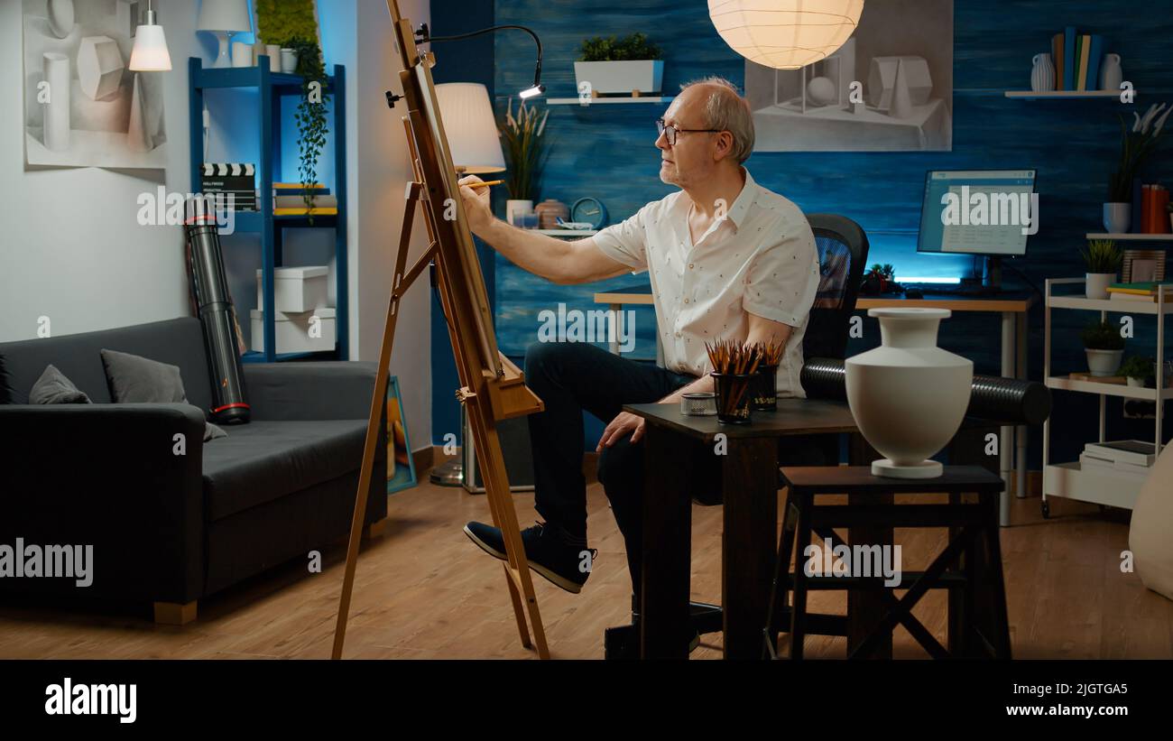 Old person with creative skills drawing vase design for hobby with art ...