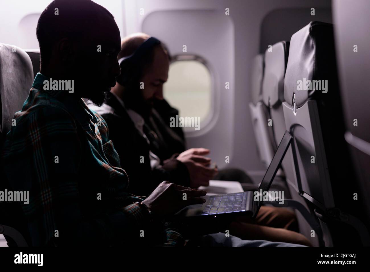 Diverse group of tourists travelling abroad by airplane, flying with ...