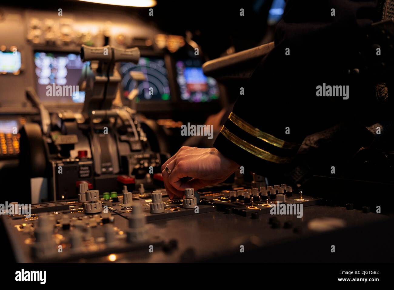 Woman aircrew switching control panel buttons on dashboard command ...