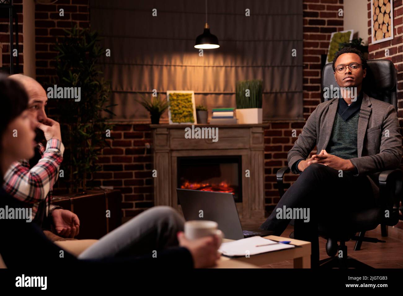Portrait of marriage counselor listening to unhappy couple at therapy ...