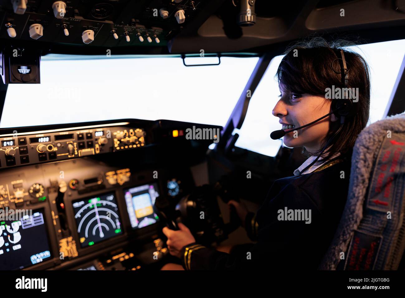 Aircrew member flying plane from cockpit with dashboard command and ...
