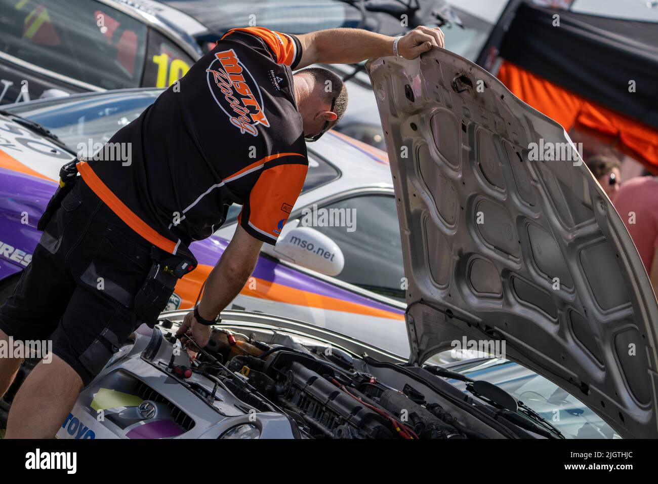 Engineer At Work Under Engine Bay In Paddock Stock Photo - Alamy