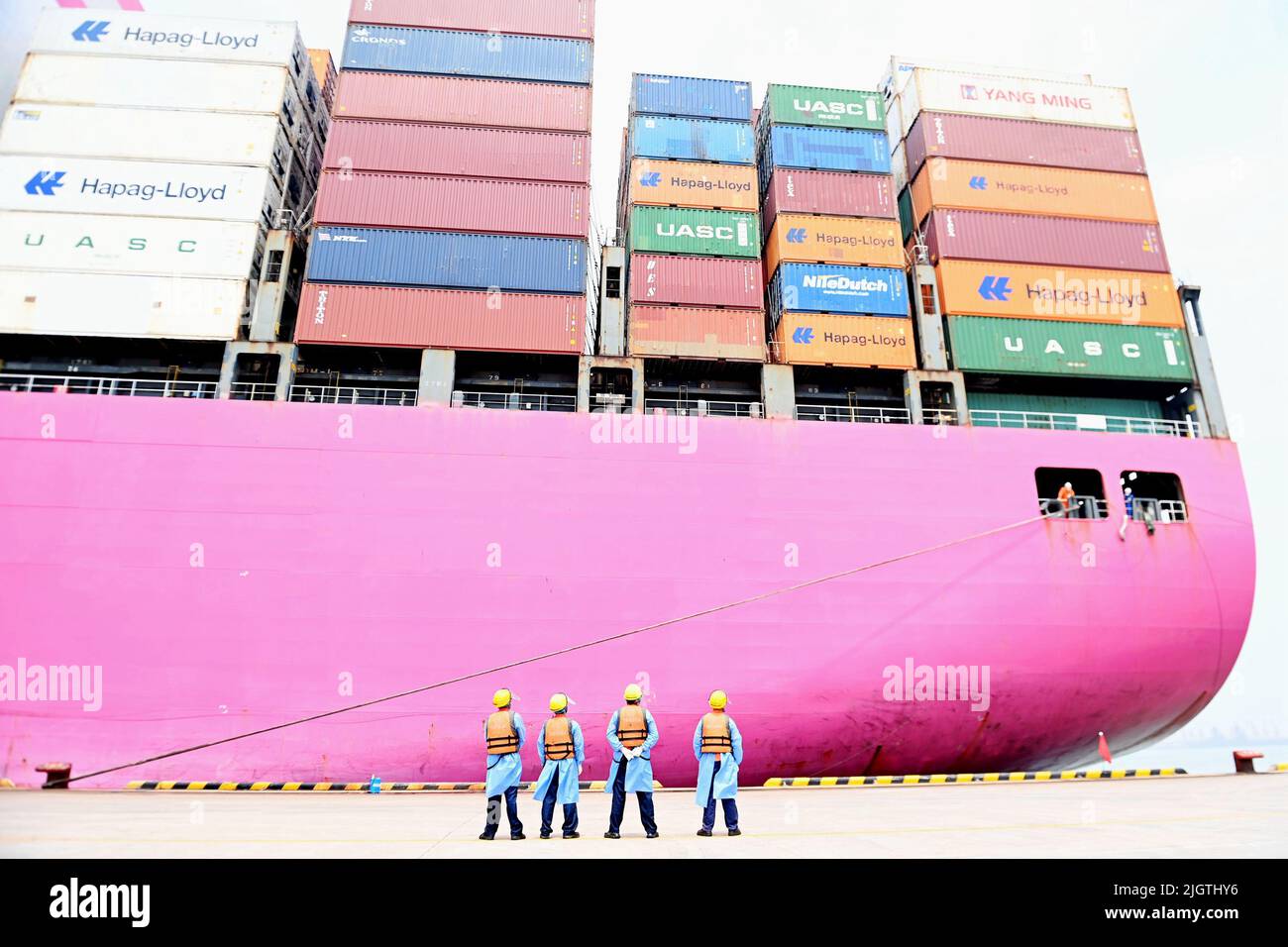 QINGDAO, CHINA - JULY 13, 2022 - Dockworkers attach cables to cargo ...