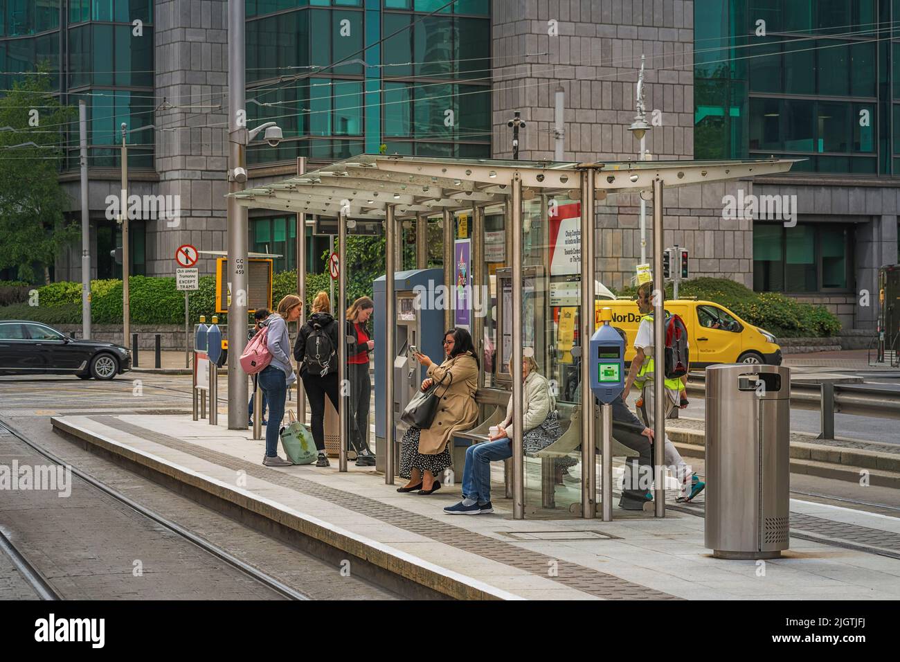 People are waiting for the tram at Busaras Luas stop. Dublin, Ireland ...