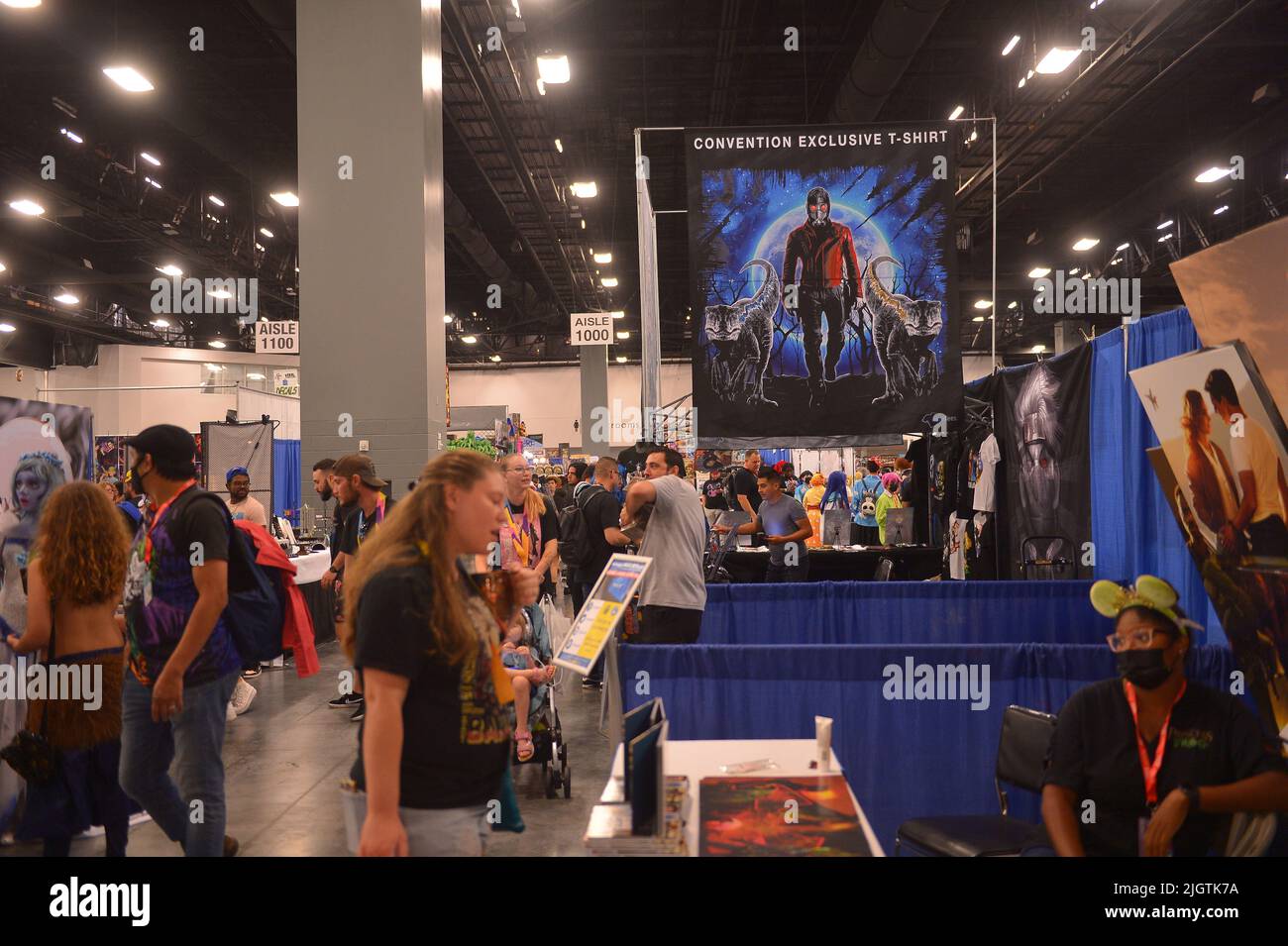 MIAMI BEACH, FL - JULY 09: Fans of SUPERCON look over merchandise at ...