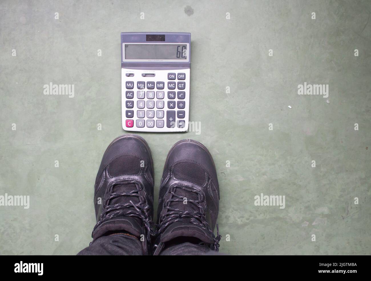 Man's feet standing on weighing machine, weighing scale Stock Photo - Alamy
