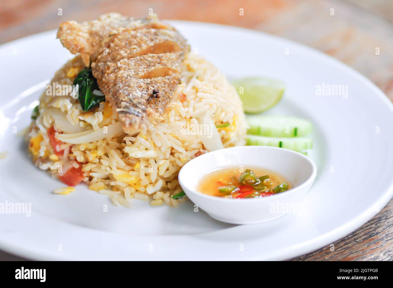 stir fried rice or fried rice with fried fish topping and sauce Stock ...