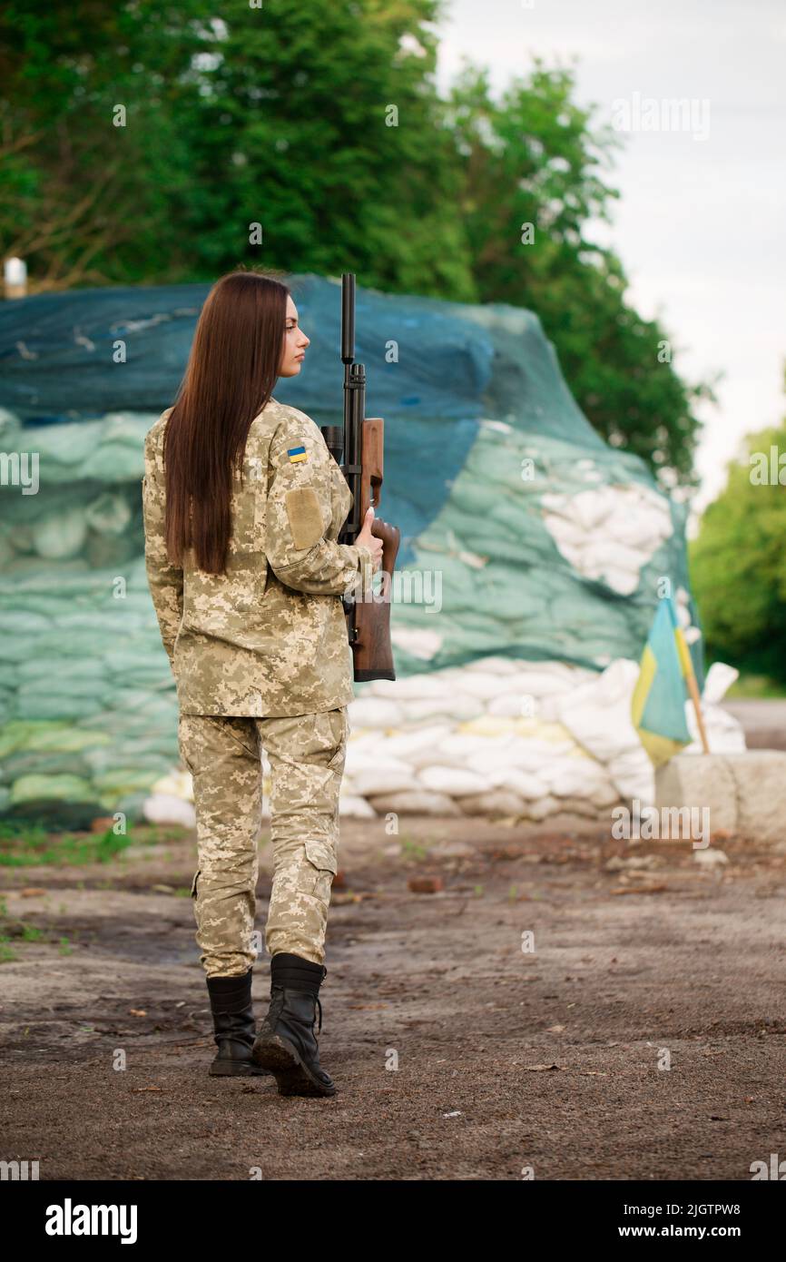 A beautiful girl with a weapon in her hands at the roadblock Stock ...