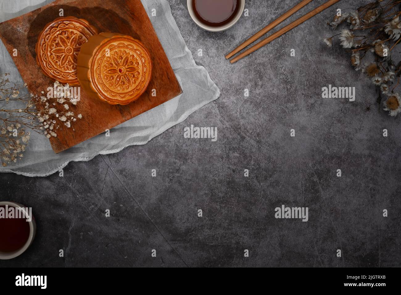 Top view traditional mooncakes on dark stone background, for Chinese mid Autumn festival ...