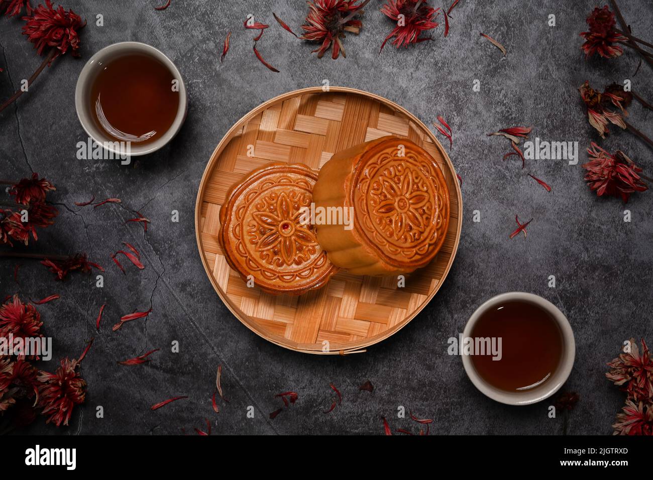 Traditional mooncakes and tea on stone background for Chinese Mid Autumn Festival celebration ...