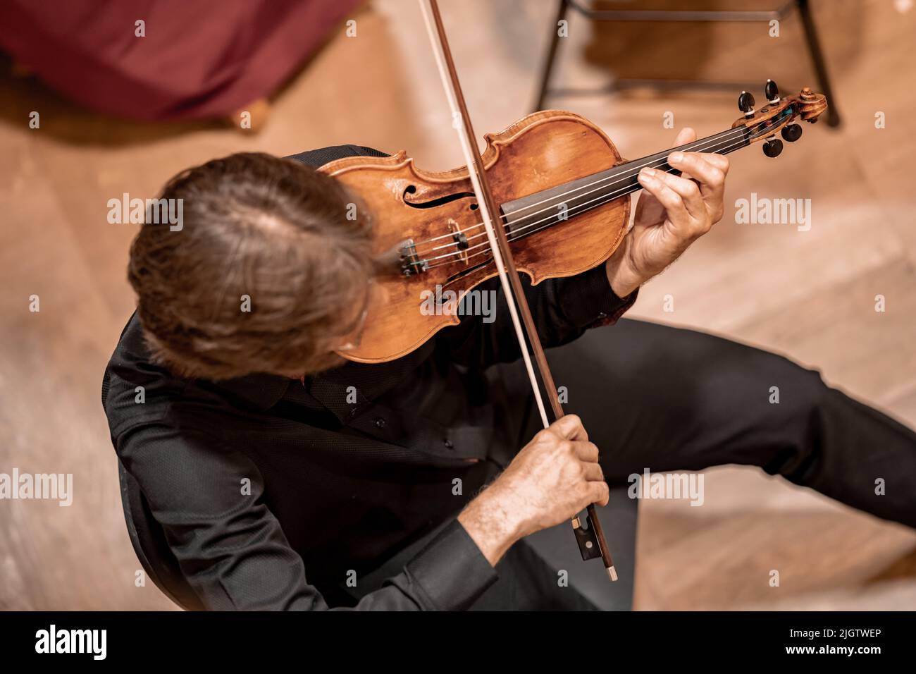 a violinist plays at a concert in the Philharmonic Stock Photo - Alamy