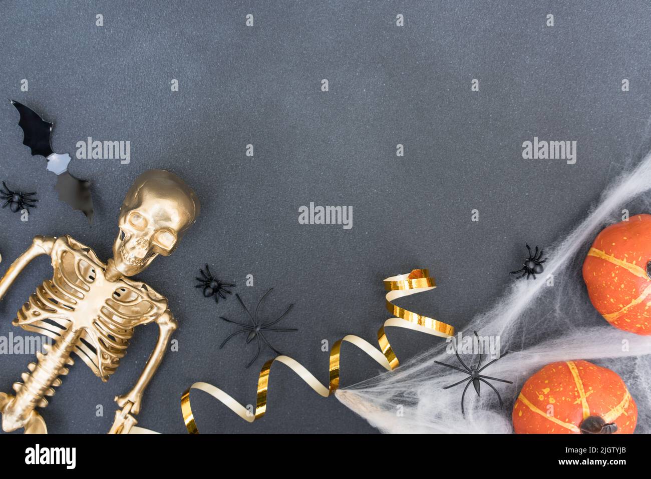 Festive halloween composition with white cobweb, spiders, pumpkins ...