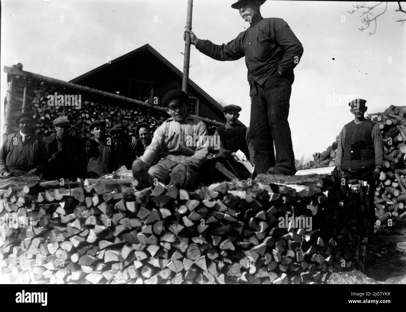 Stacking of wood at the mill. The building in the background seems to ...