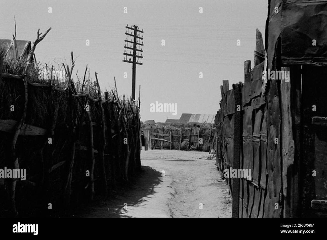 The photo taken about 1961-08-22. Two walls define the street from the ...