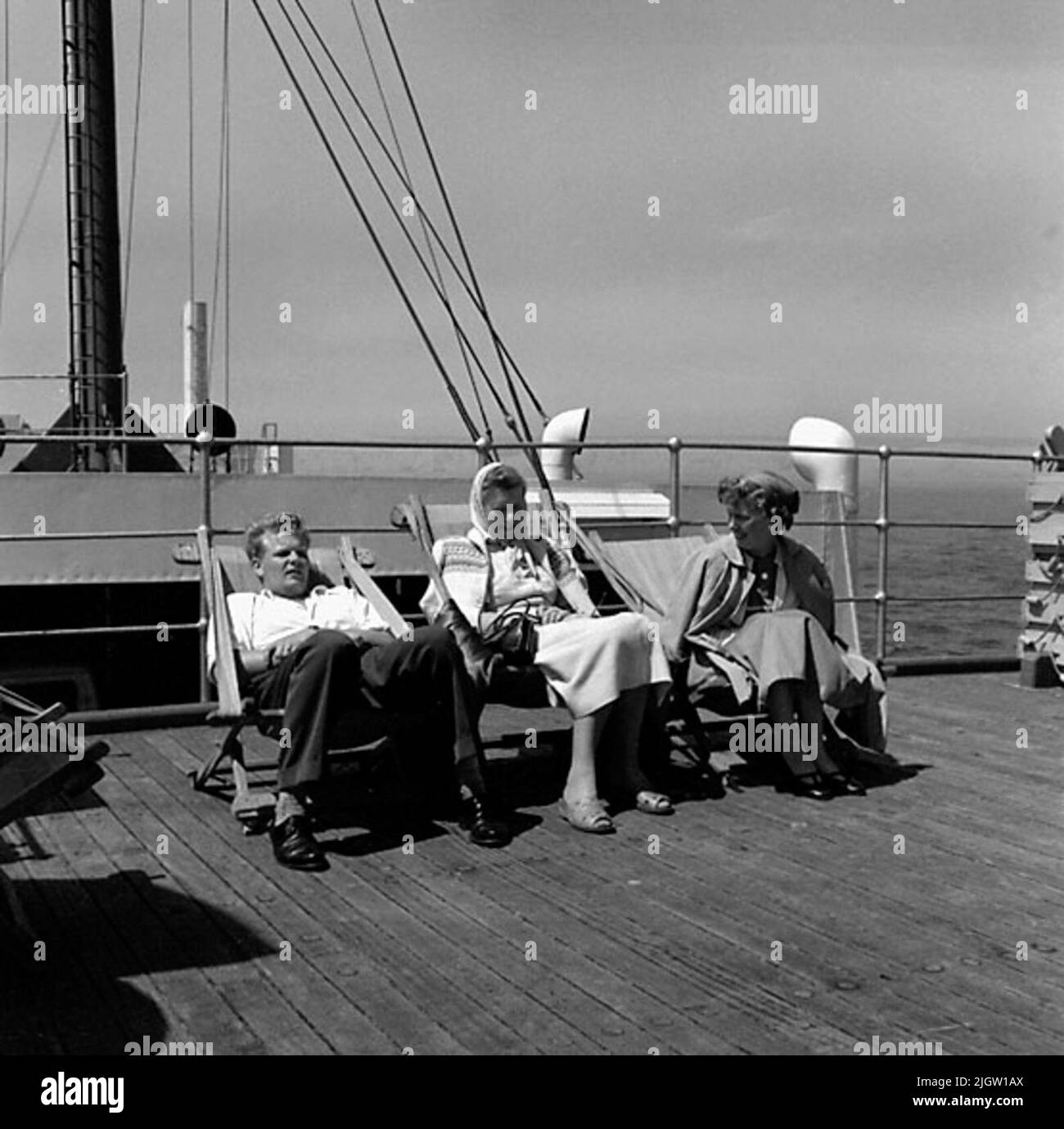 Two women man sit Black and White Stock Photos & Images - Alamy